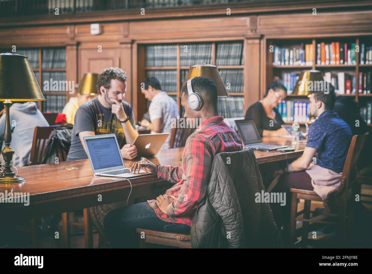People working and studying in the public library in New York City ...