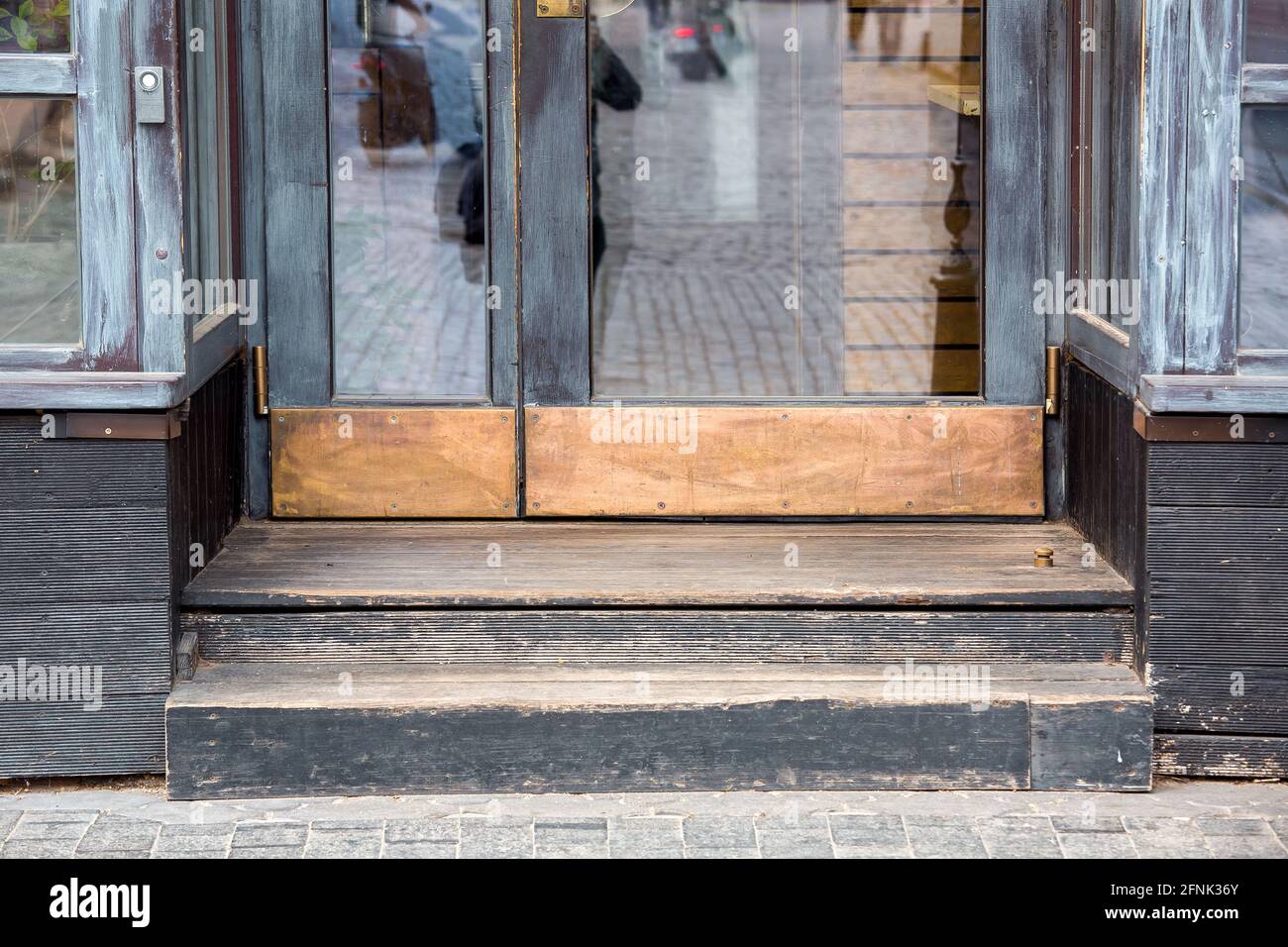 door step at the entrance to an old restaurant with a wooden facade and ...