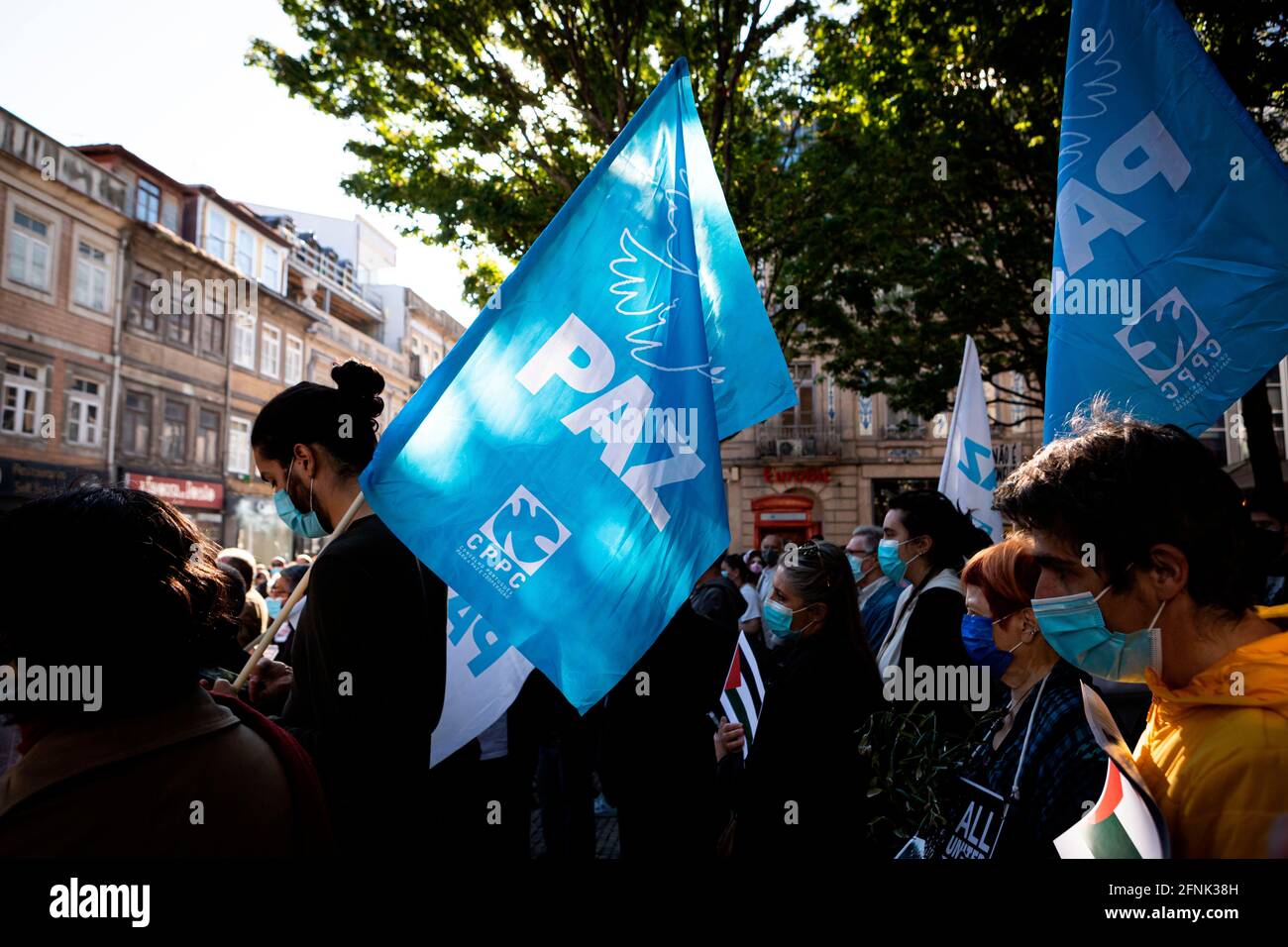 A demonstrator holds a flag with the word "Paz" (meaning peace ) during ...