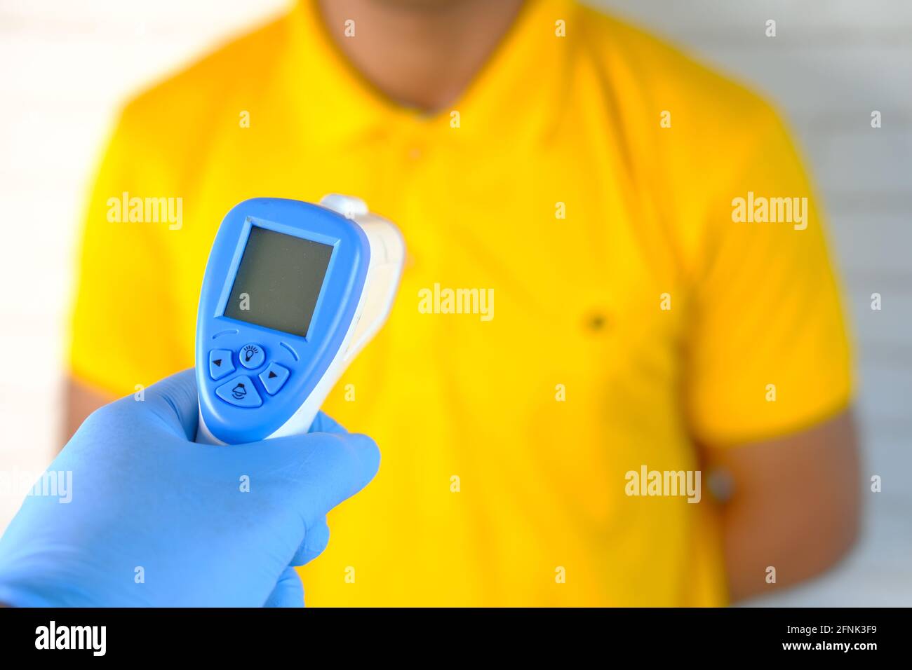 Hand holding infrared thermometer to measuring temperature Stock Photo ...