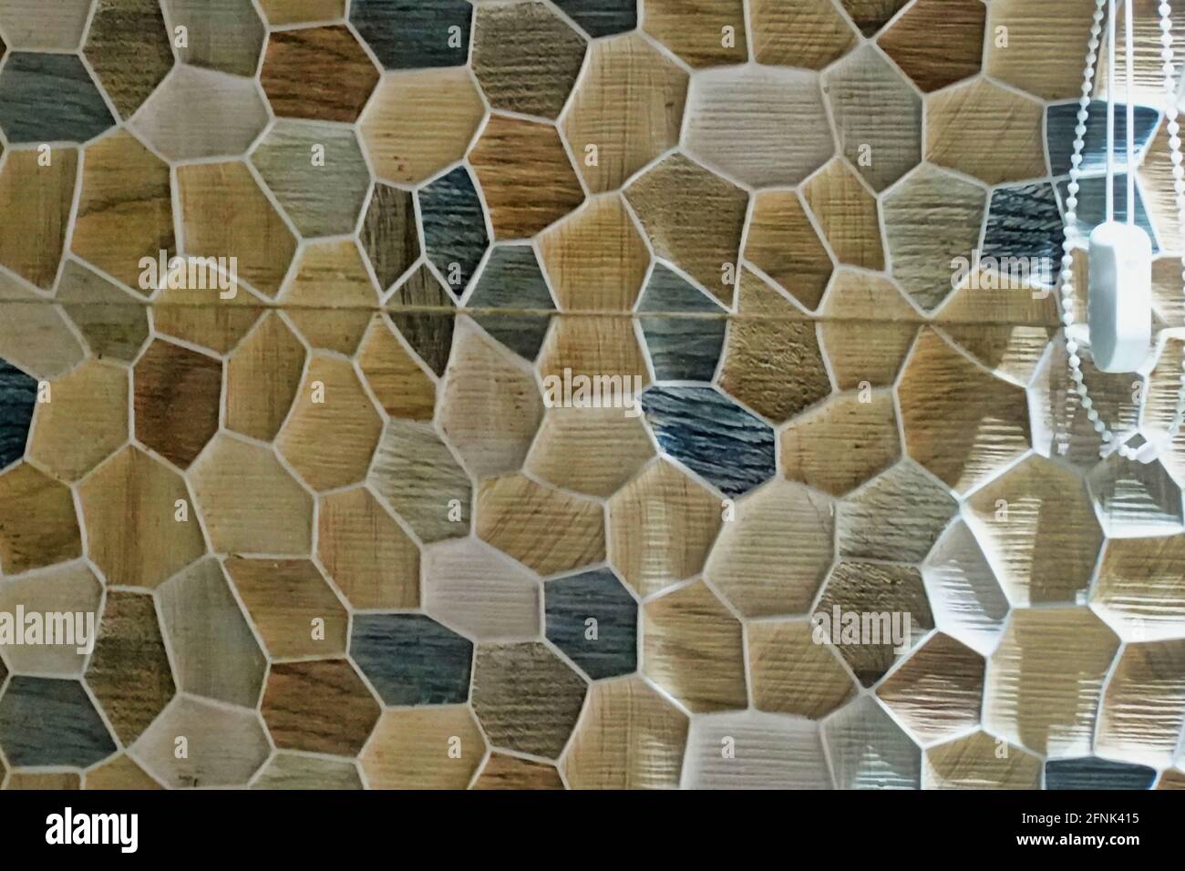 Decorative stone wall with colorful tile decors Stock Photo - Alamy
