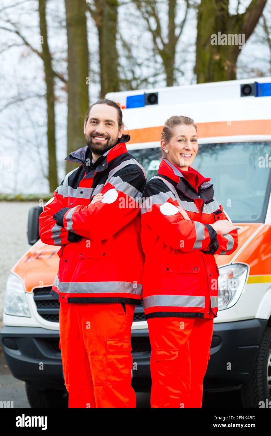 Emergency doctor and nurse standing in front of ambulance car Stock ...