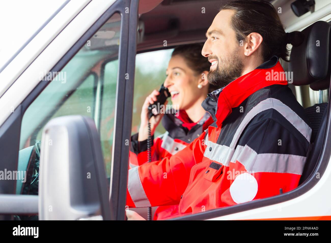 Emergency doctor and nurse driving ambulance Stock Photo - Alamy