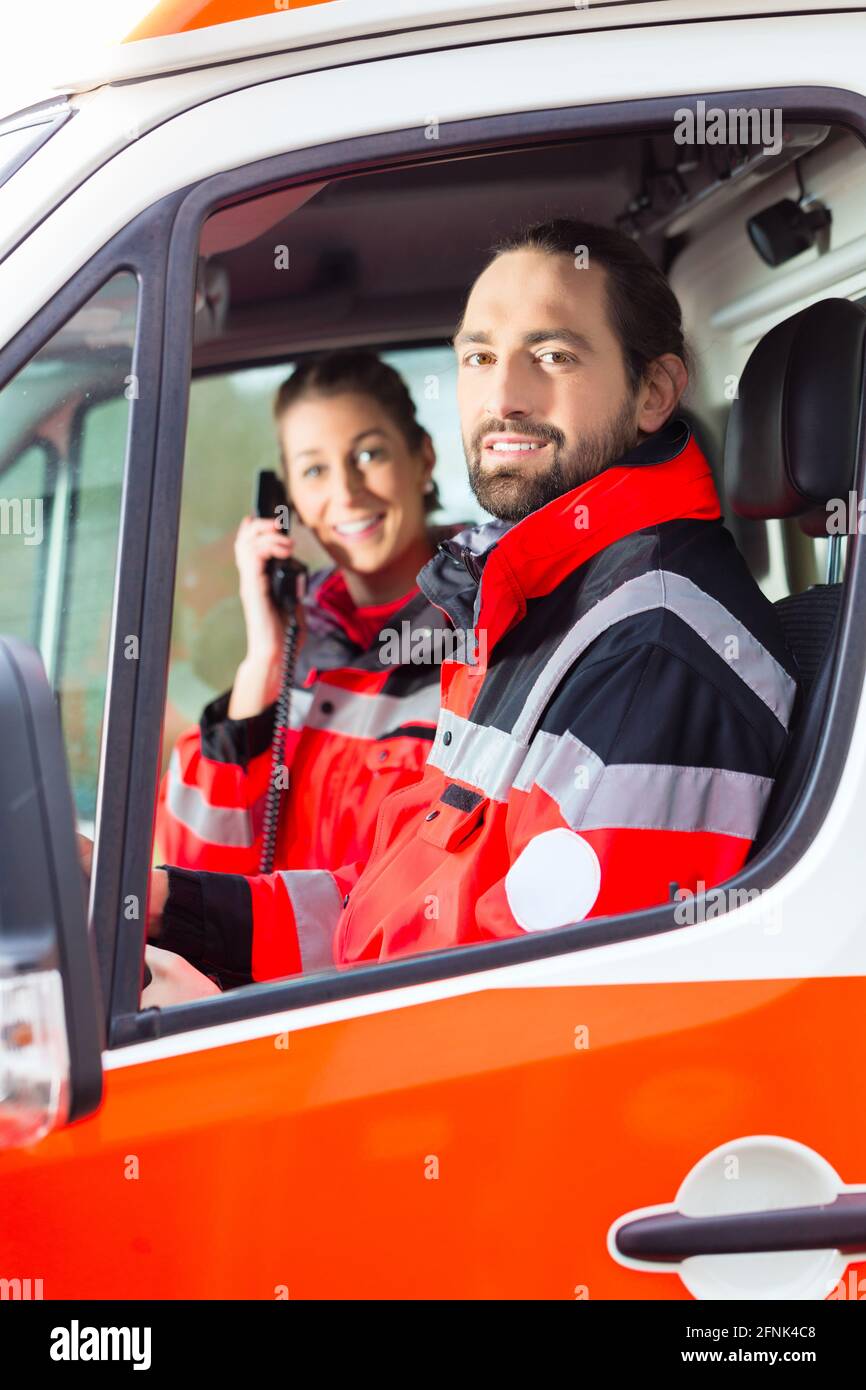 Emergency doctor and nurse driving ambulance Stock Photo - Alamy