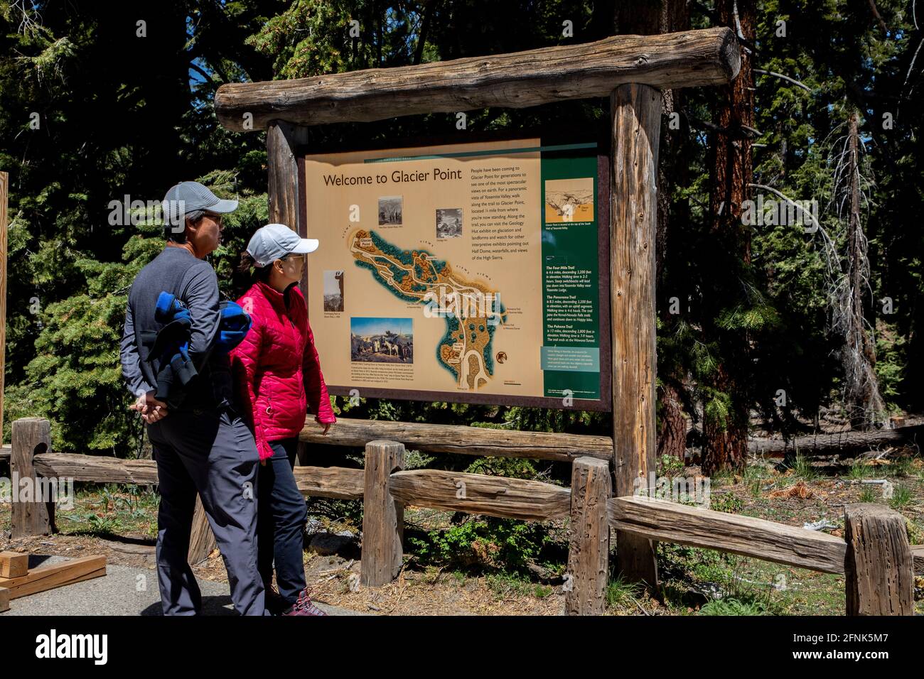 Visitors up at Glacier Point checking out the map of the valley below ...