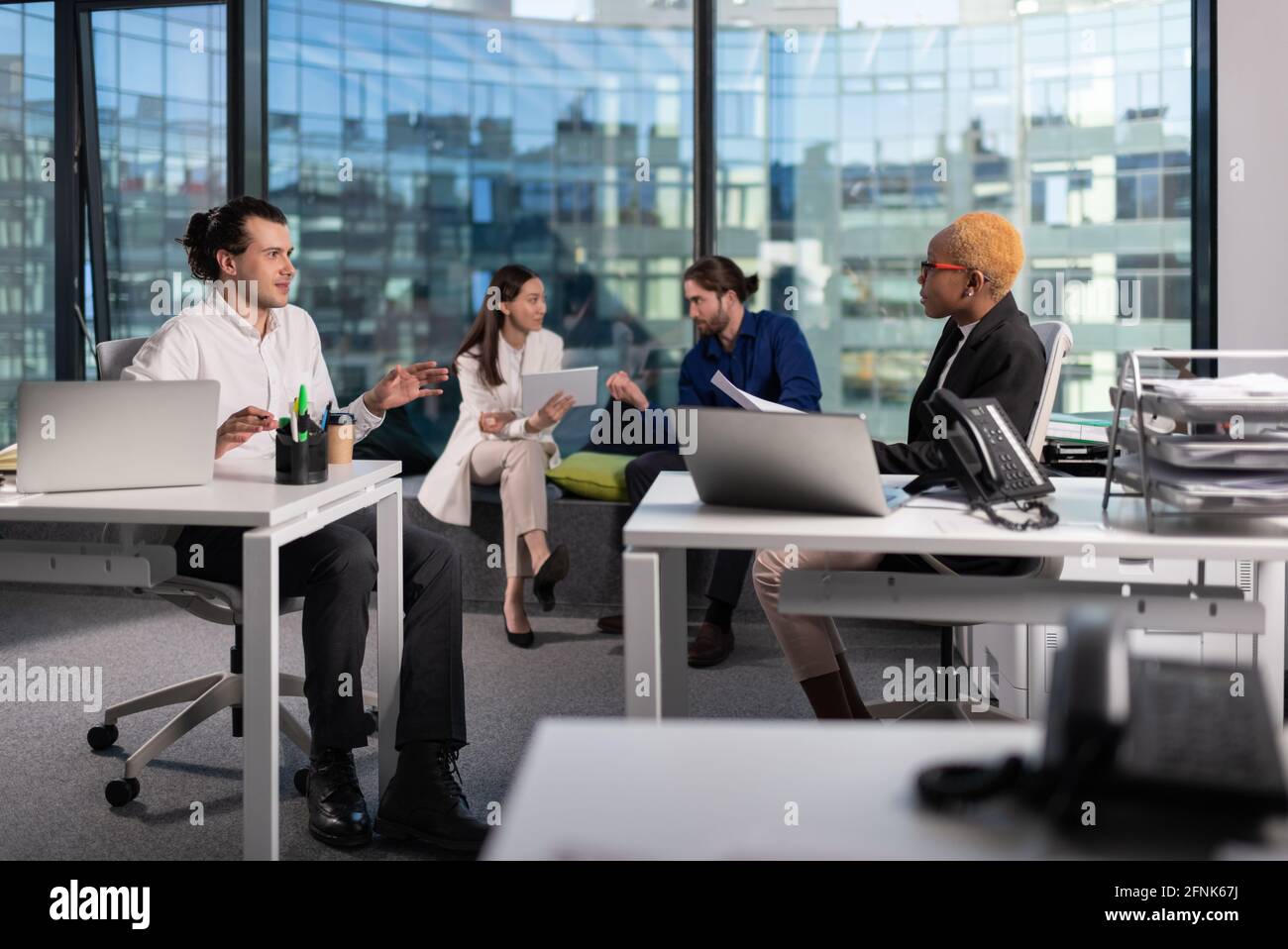 Multiracial colleagues having business meeting in office Stock Photo ...