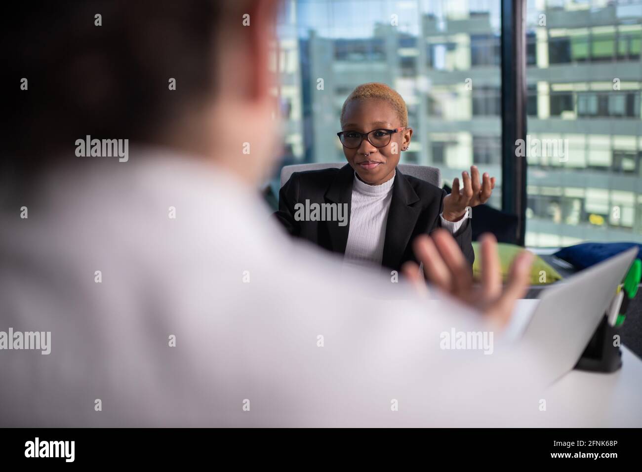 Black boss speaking with recruit Stock Photo - Alamy