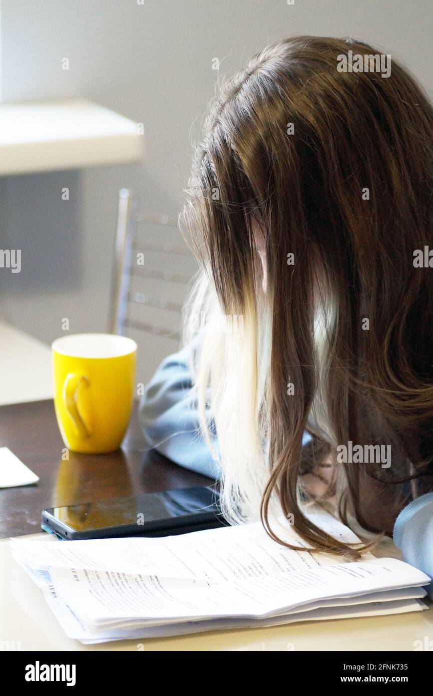 Teen girl taking exam and studying at home Stock Photo - Alamy