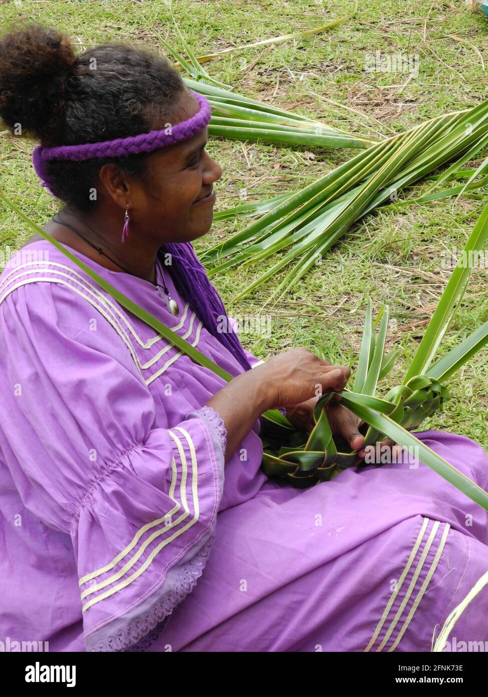 View of South Pacific woman weaving baskets on the island of Lifou ...