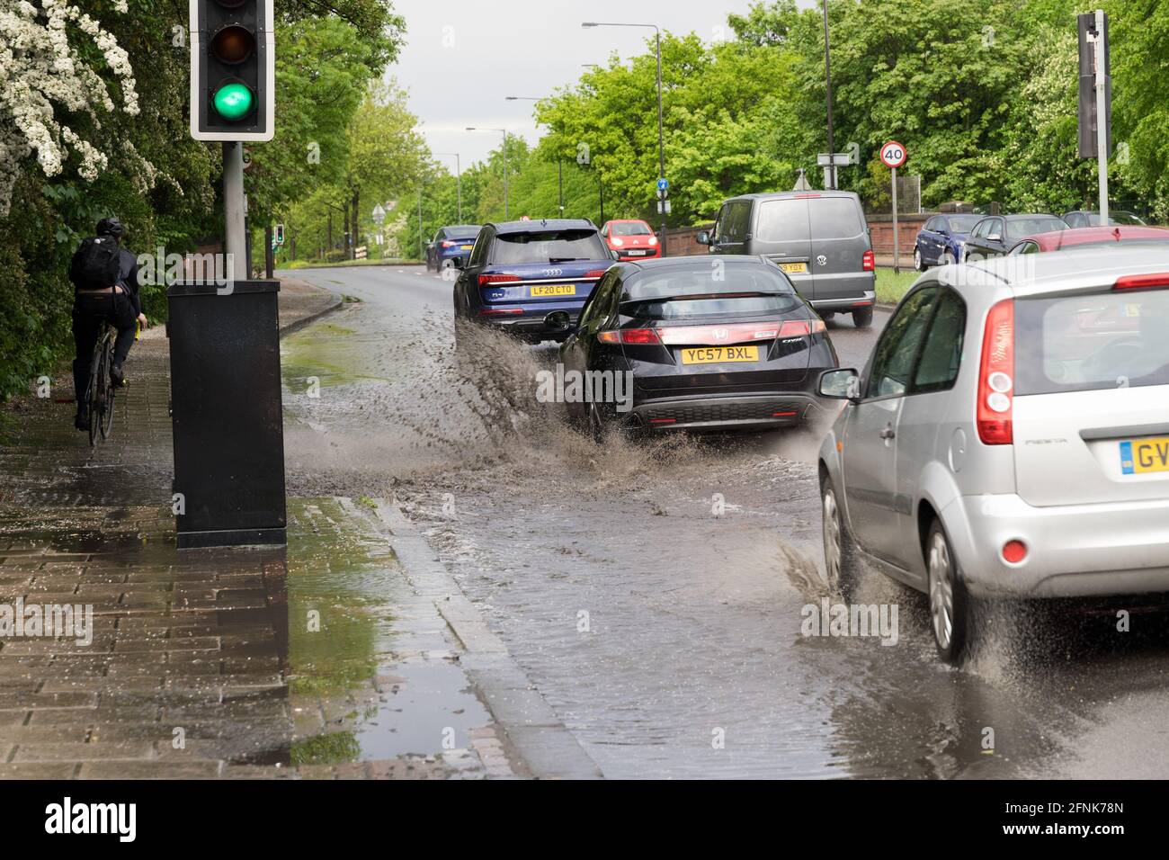 cyclist on pavement soaked with Splash from flash flood on south ...