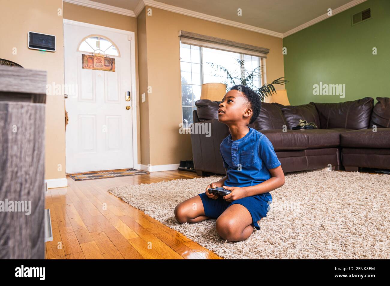 African boy sitting on floor hi-res stock photography and images - Alamy