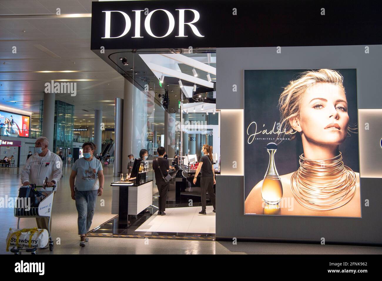 SHANGHAI, CHINA - MAY 16, 2021 - Customers walk past a Dior cosmetics ...