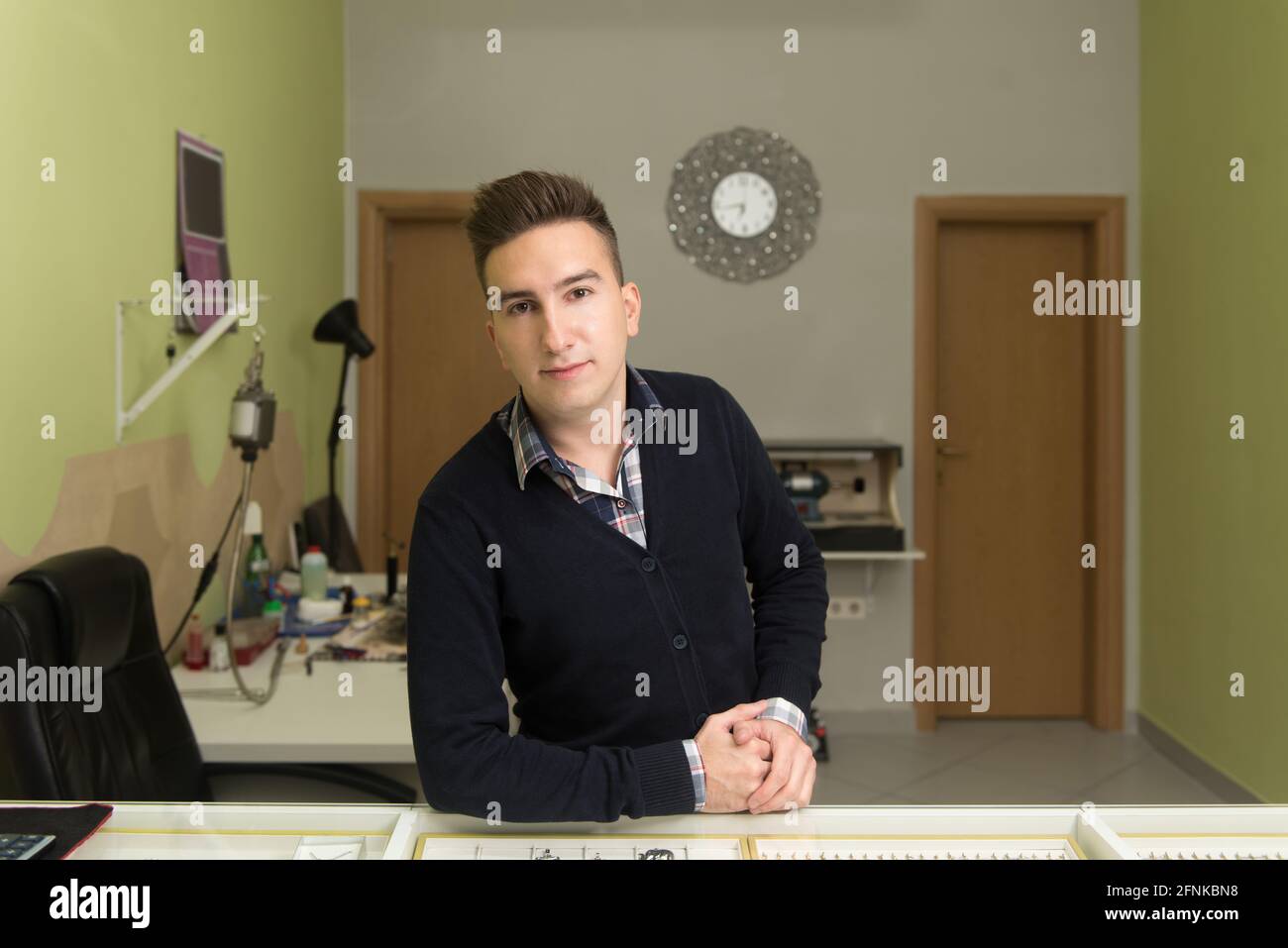 Portrait of a Young Salesperson Man Standing Behind a Counter in His ...