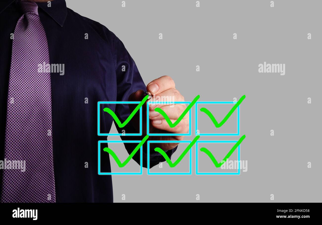 Businessman ticking off all boxes on a checklist Stock Photo - Alamy