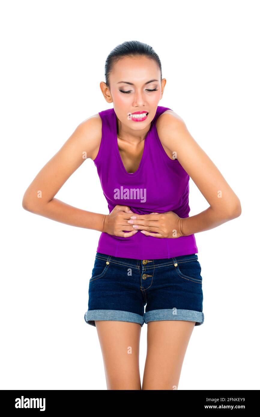 Painful woman touching stomach over white background Stock Photo - Alamy