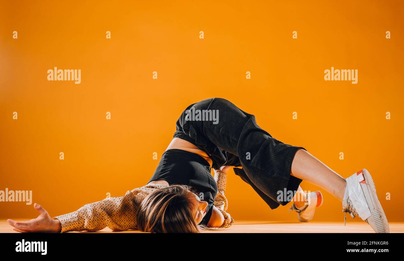 Modern dancing performer doing acrobat skills during a dance practice ...