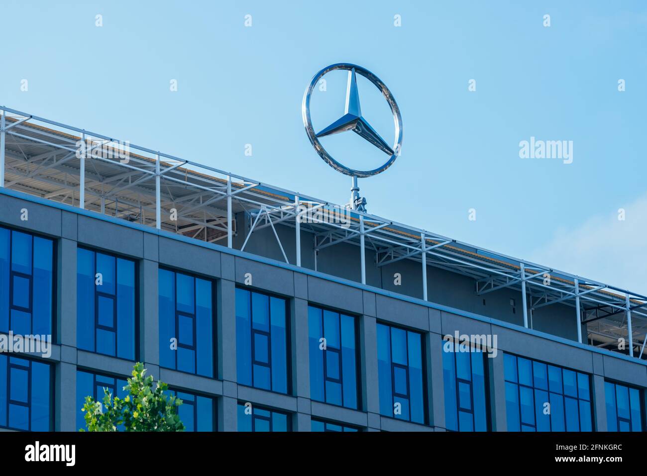 Mercedes-Benz three-pointed star logo on top of a building Stock Photo ...
