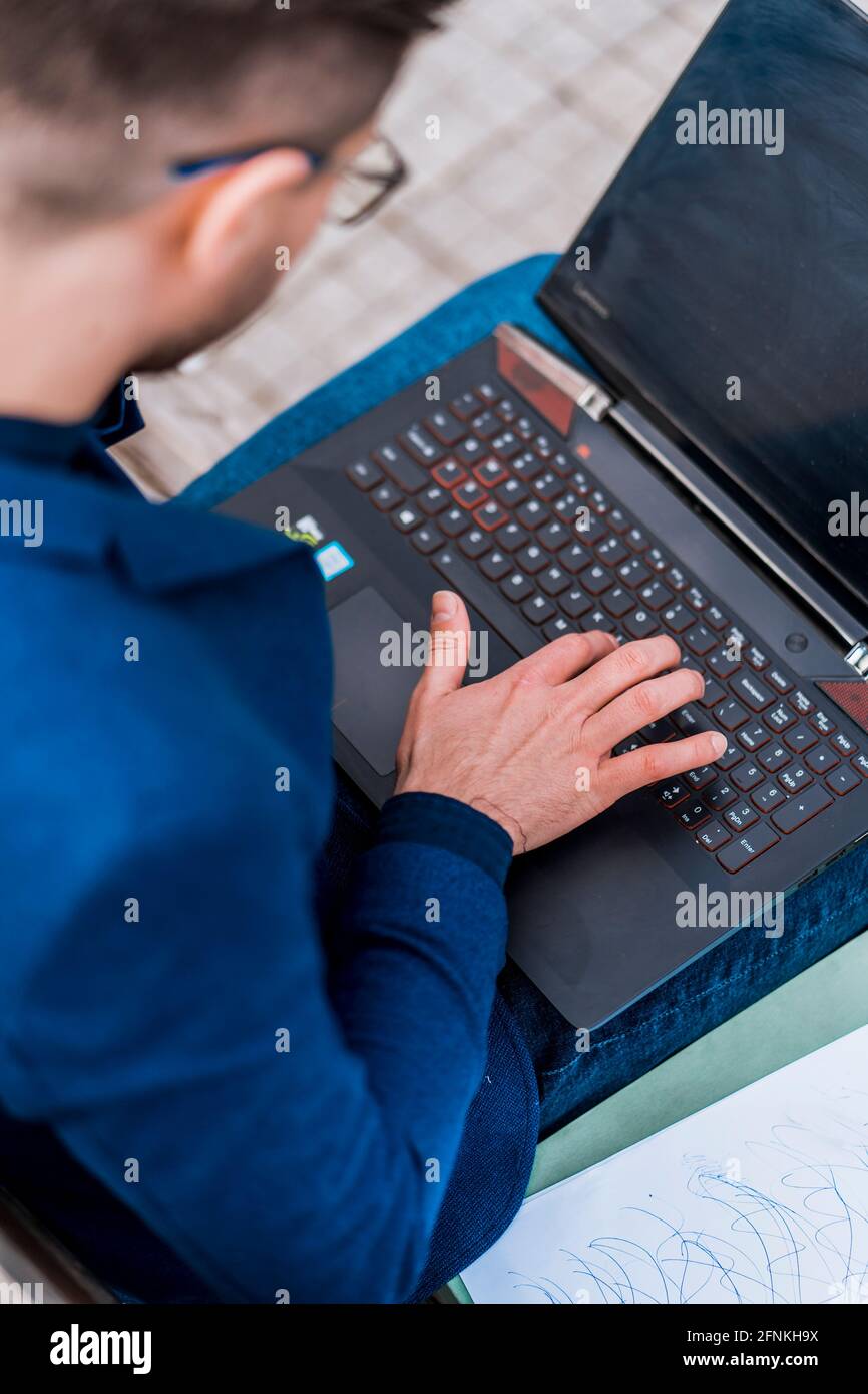Elegant businessman is having phone conversation while working on lap ...