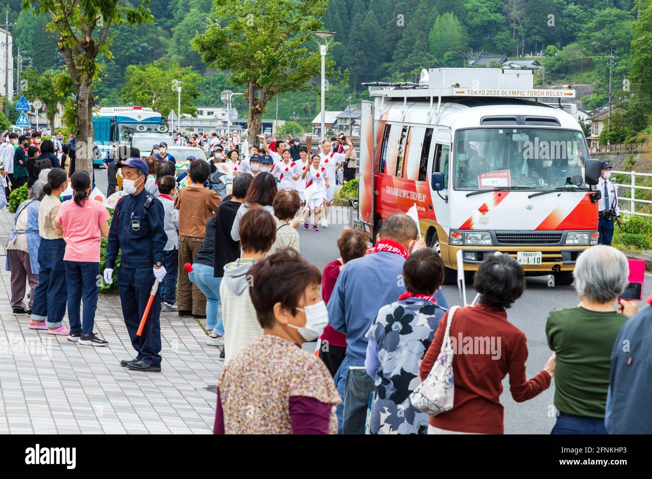 Local torchbearers run during the Tokyo 2020 Olympic torch relay in ...