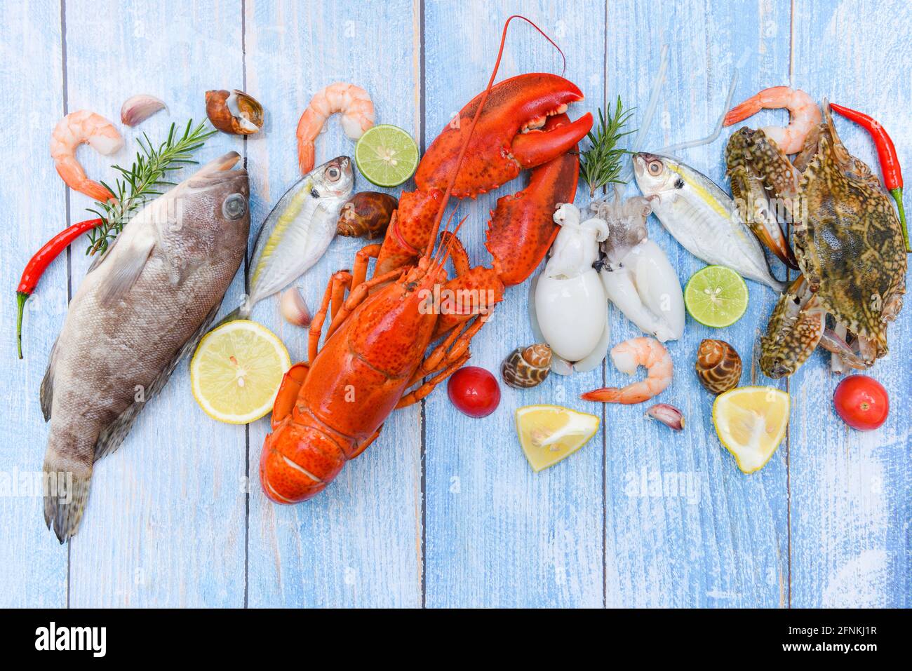 Fresh raw seafood on ice with herbs and spices at the fish market food ...