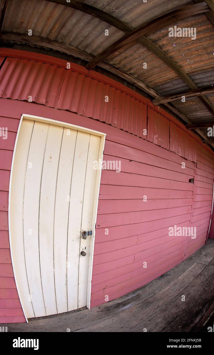 A retro pink and yellow building with curved features produced by a ...