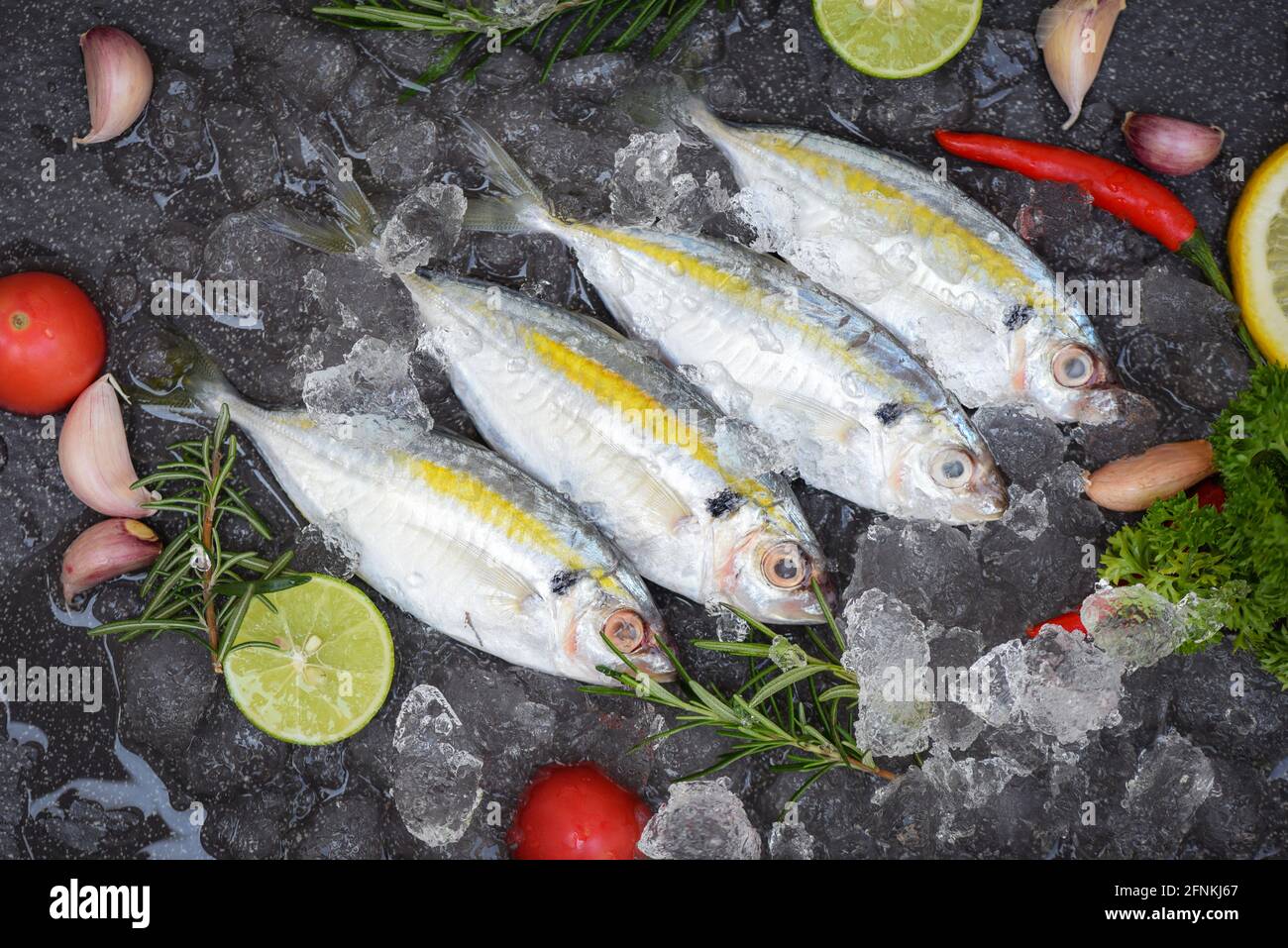 Fresh fish raw Yellow-stripe scad with lemon, Mackerel fish on ice for ...