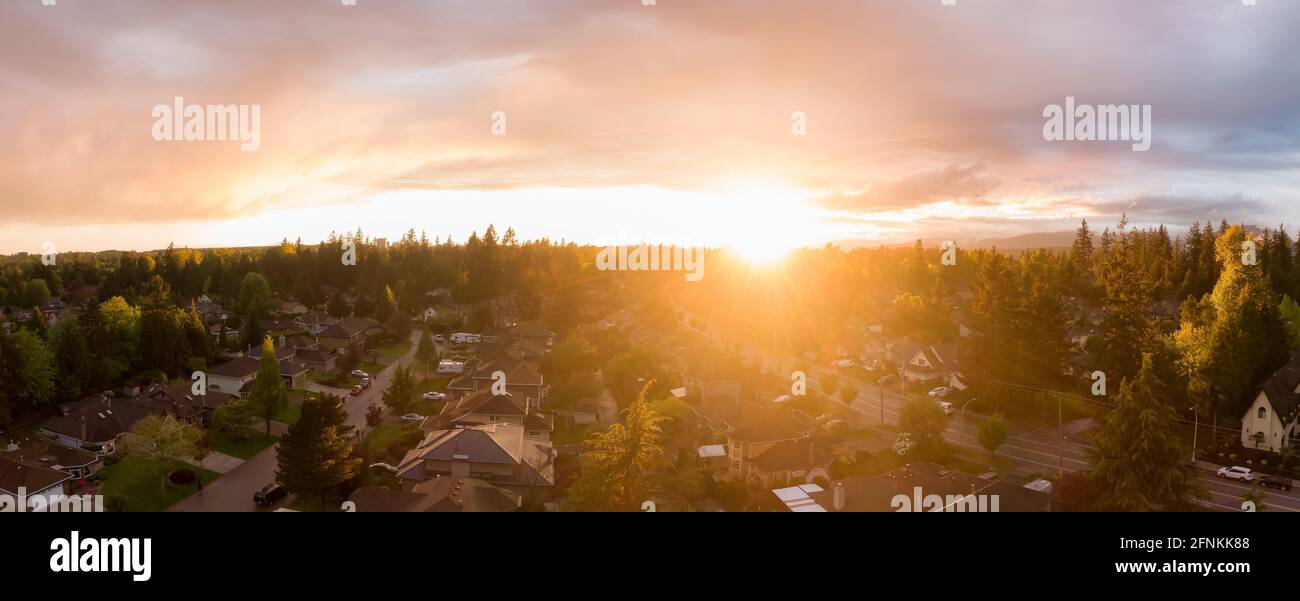 view of a suburban neighborhood during a vibrant and colorful sunset ...