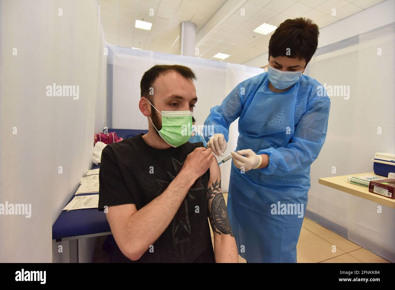 A healthy worker injects a dose of AstraZeneca Covid-19 vaccine to a ...