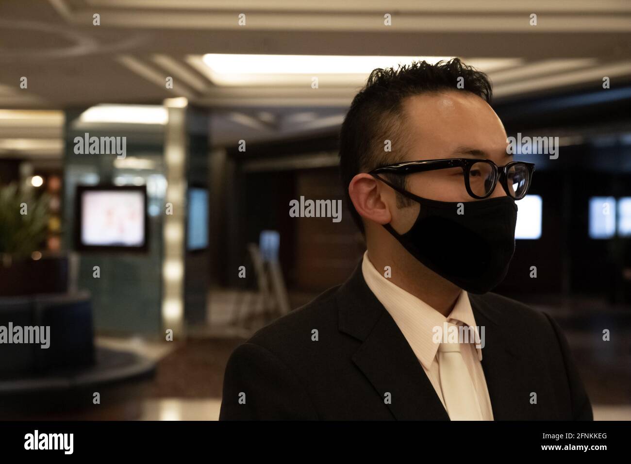 Security guard in suit standing in reception area of hotel Stock Photo ...