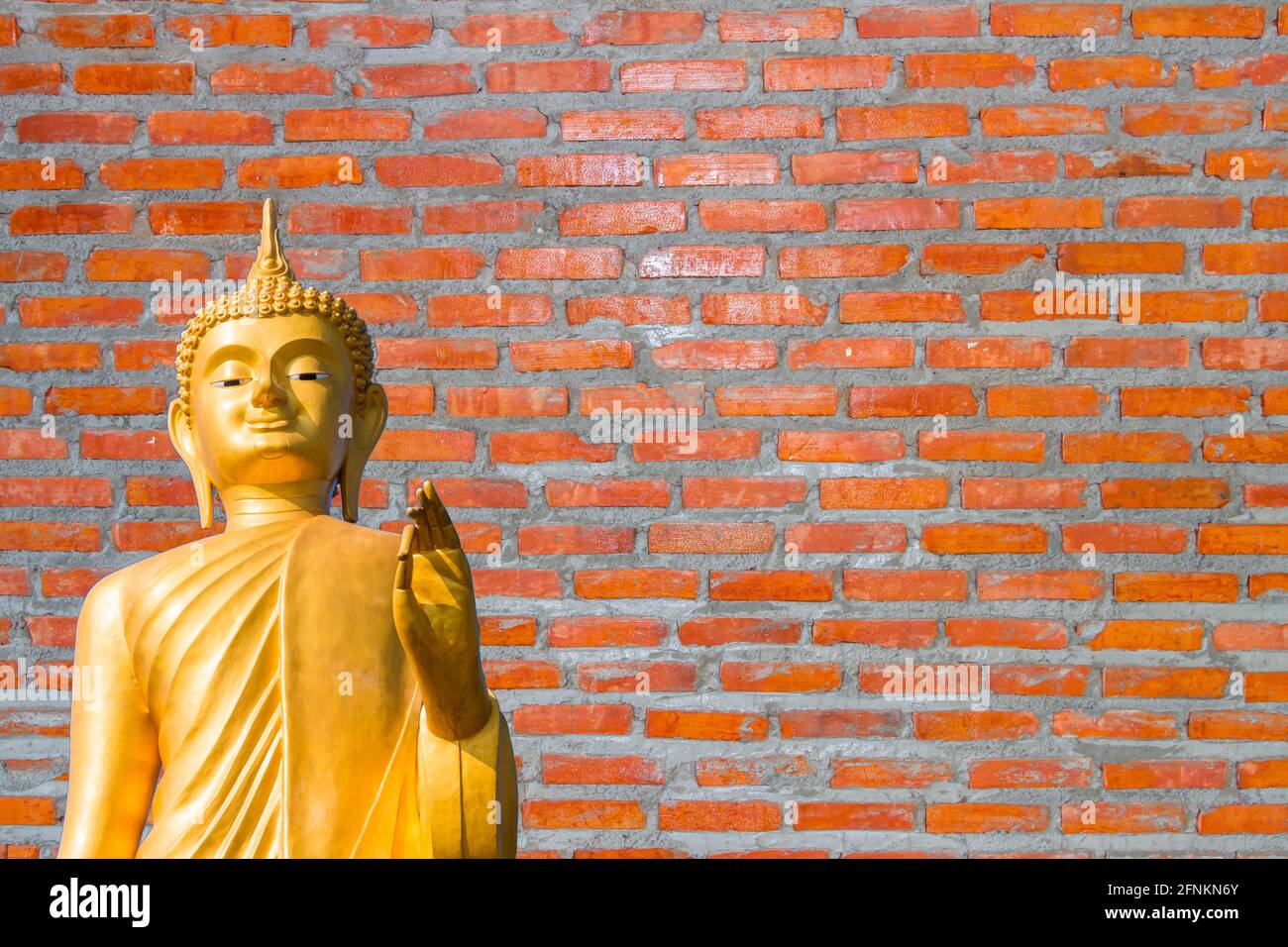 golden Buddha on Red brick wall texture background Stock Photo - Alamy