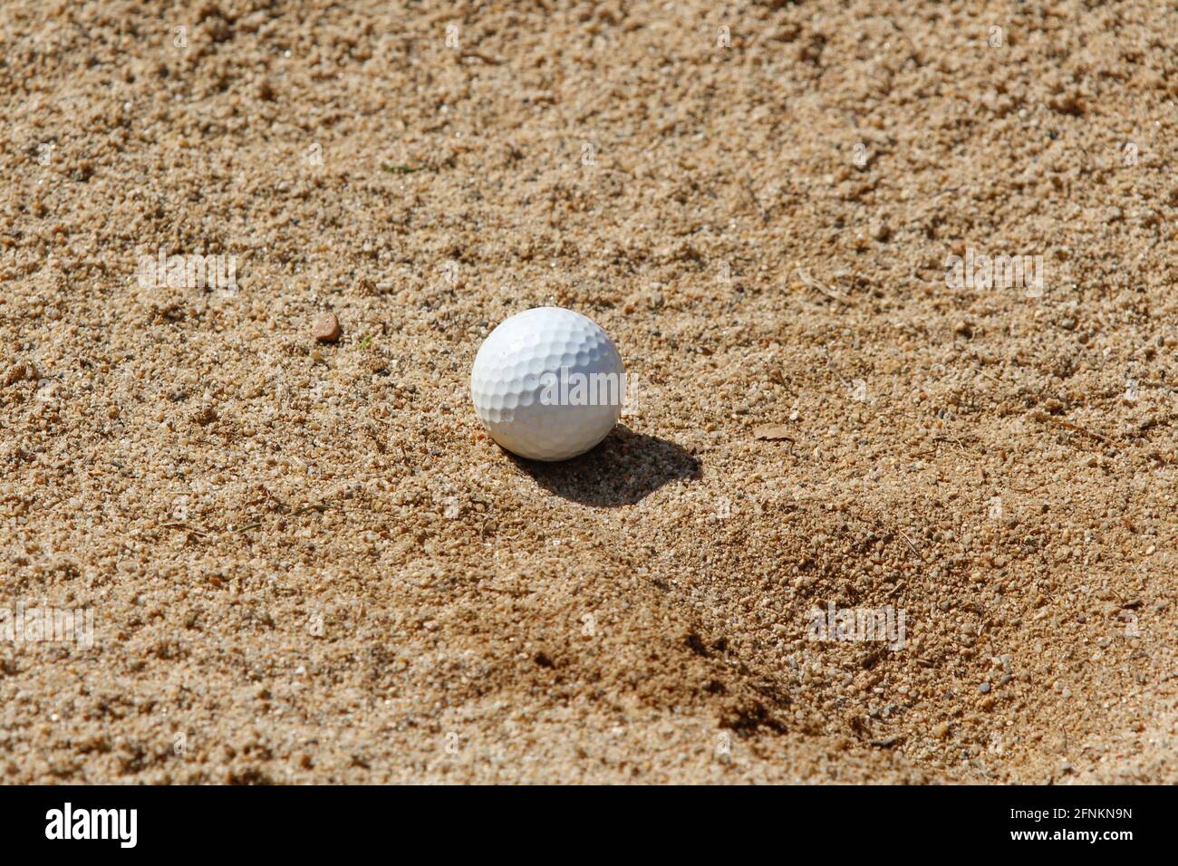 golf ball in a sand trap Stock Photo - Alamy