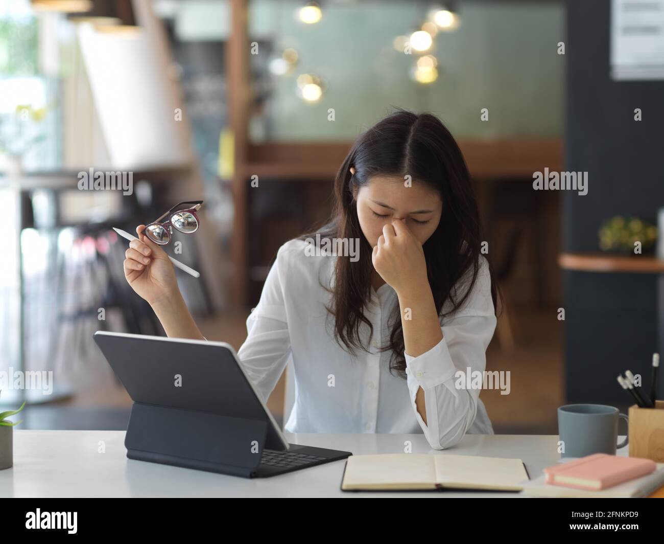 Stressed young businesswoman upsetting about the project while working ...