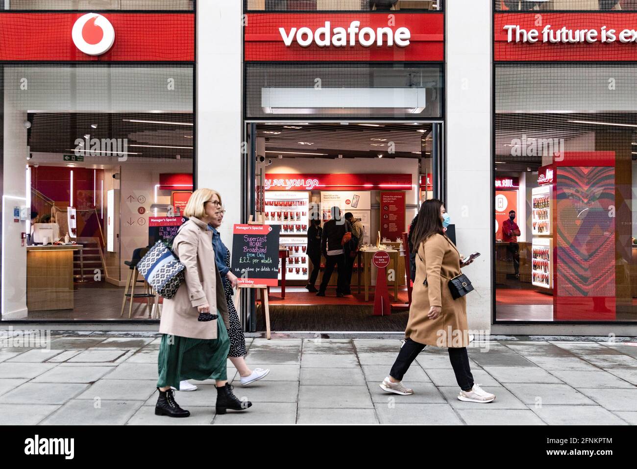 People passing Vodafone telecom shop. The Prime Minister announced that ...
