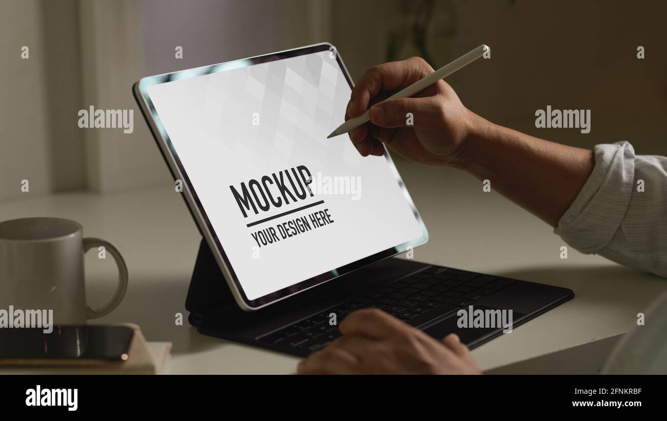 Side view of male hand using digital tablet with stylus pen on ...