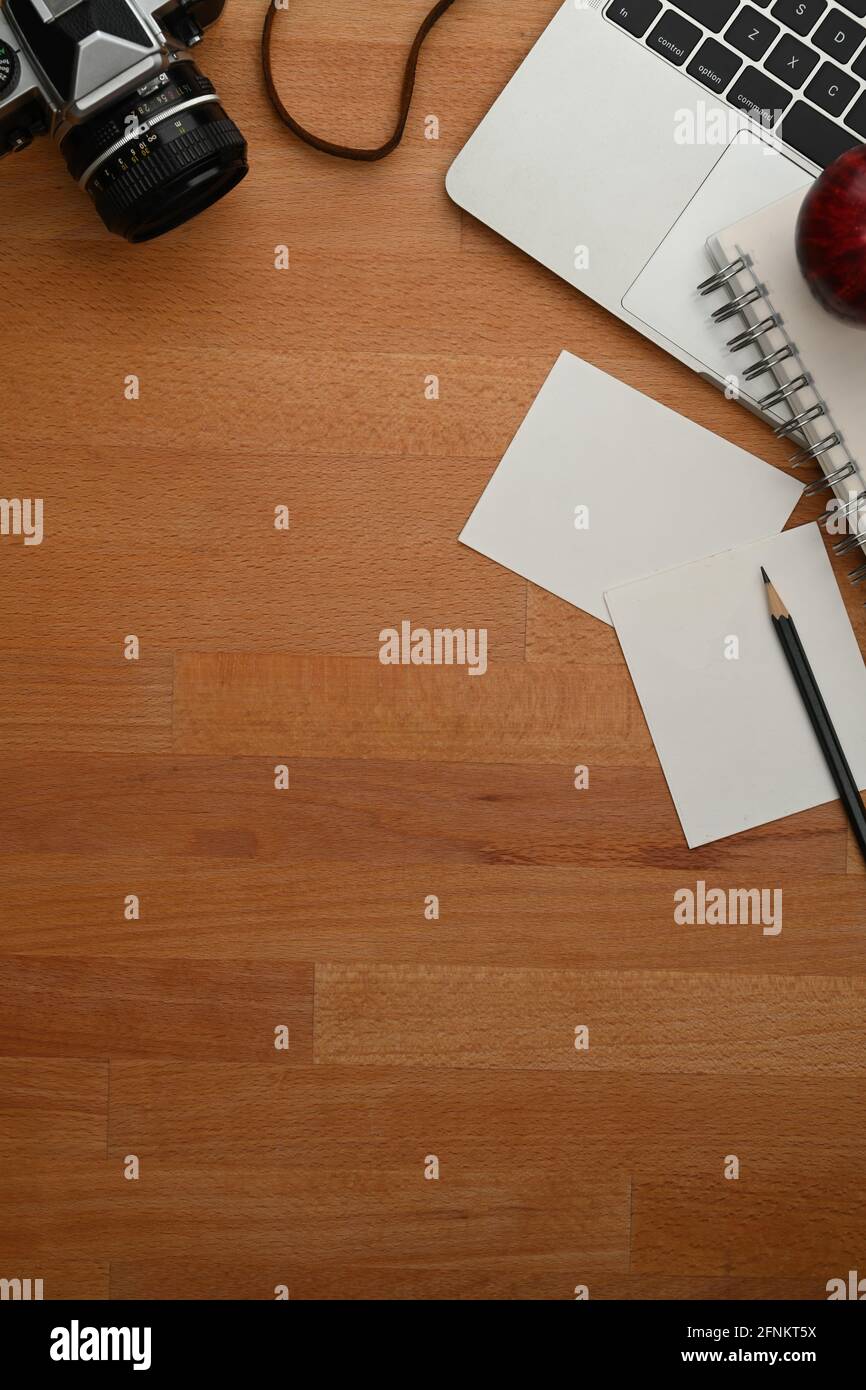 Top view of worktable with stationery, camera, laptop and copy space in ...