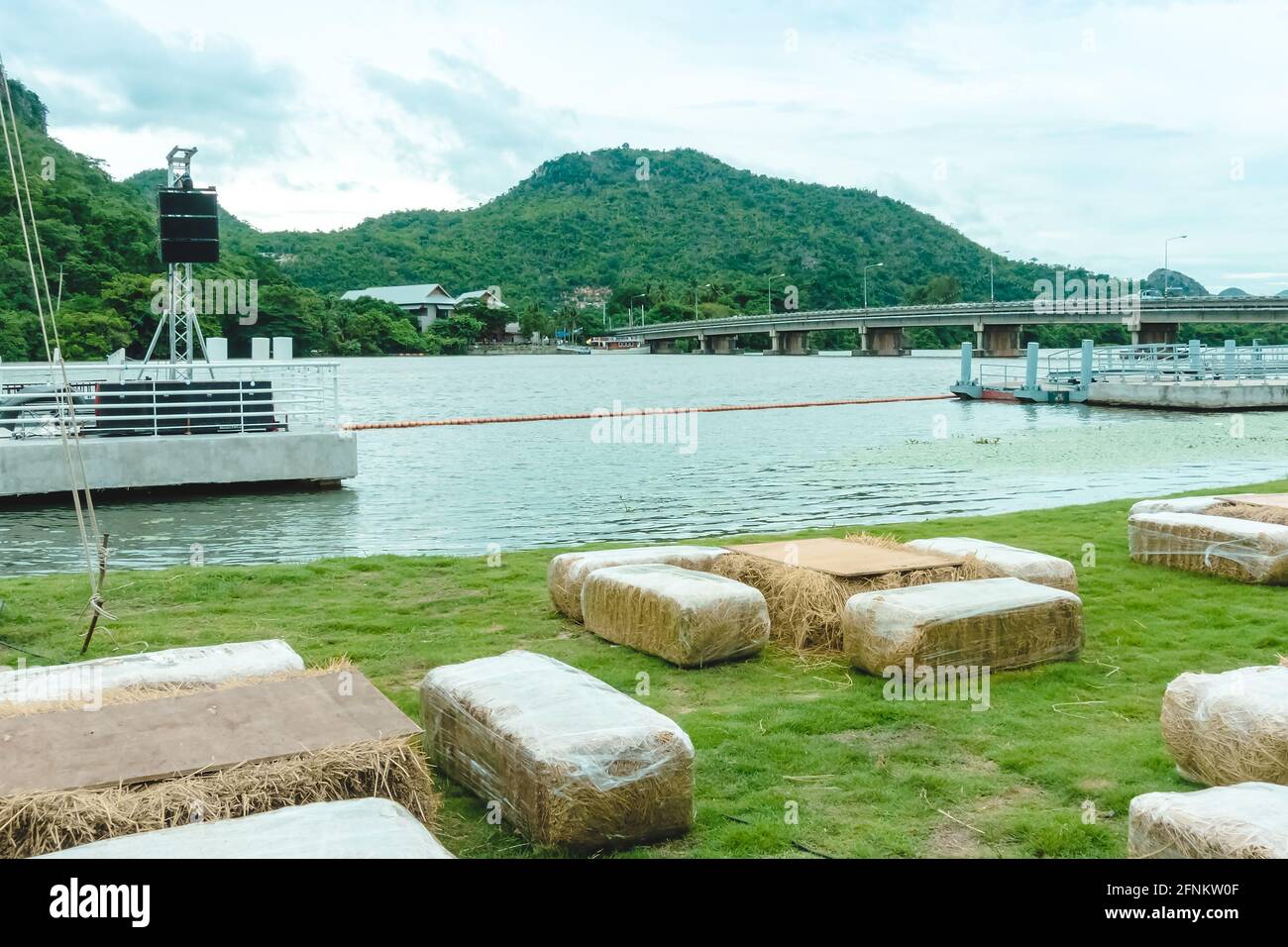 Seats and tables made from straw bales for event and party laid on lawn ...