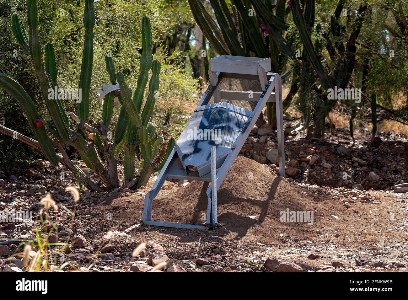 Abandoned sapphire mining sieve amongst rocks and cacti on fossicking ...