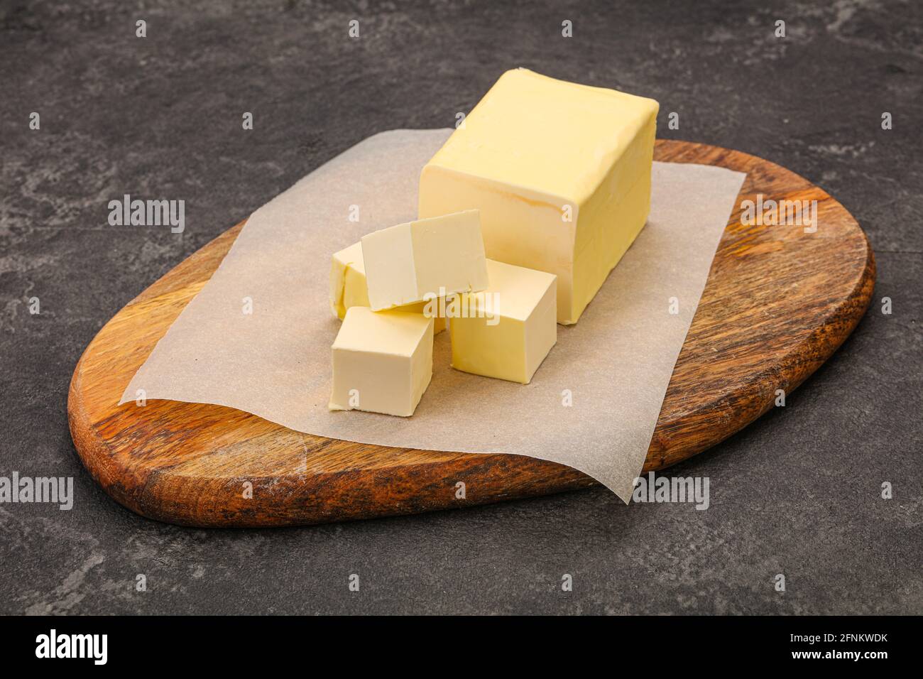 Dairy natural yellow butter piece over board Stock Photo - Alamy