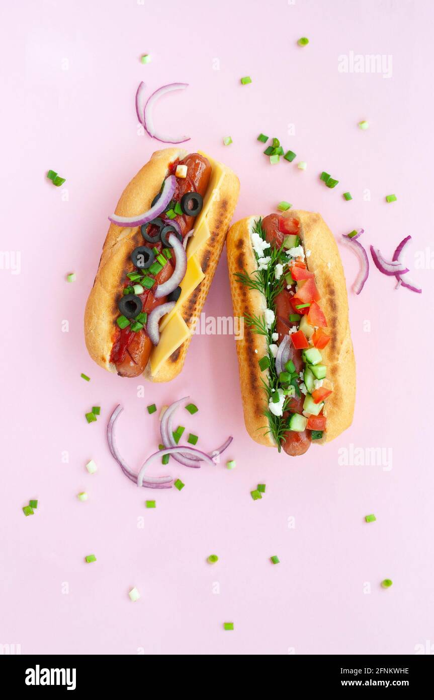 Flat lay of freshly cooked hot dogs with sausages, vegetables, cheese ...
