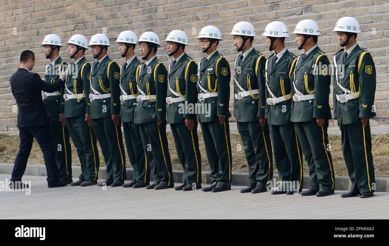 Chinese security forces standing in strait line during an order by ...