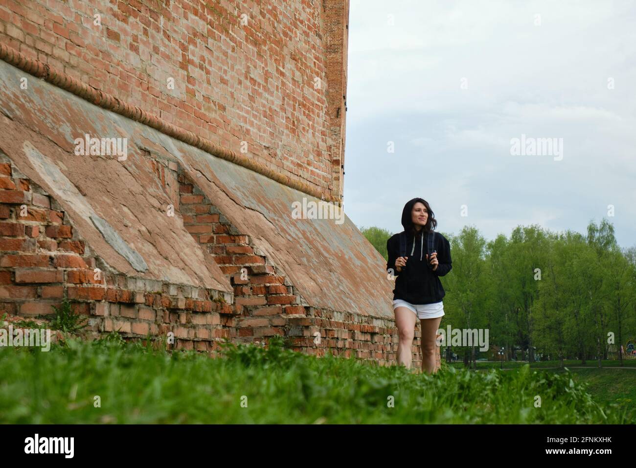 Woman walking along a wall hi-res stock photography and images - Alamy