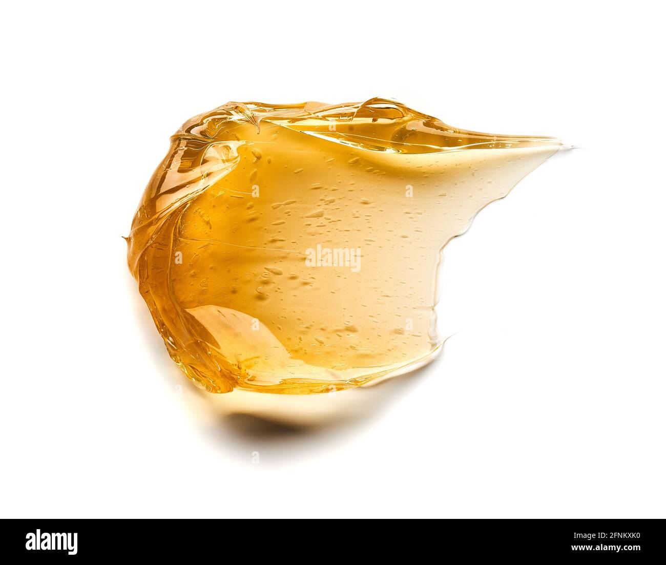 Transparent yellow smear of face cream or golden honey isolated on ...