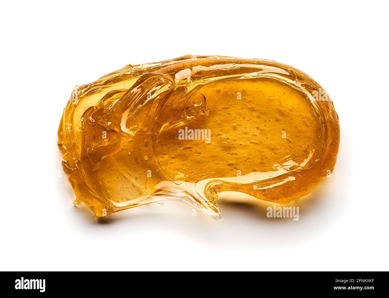 Transparent yellow smear of face cream or golden honey isolated on ...