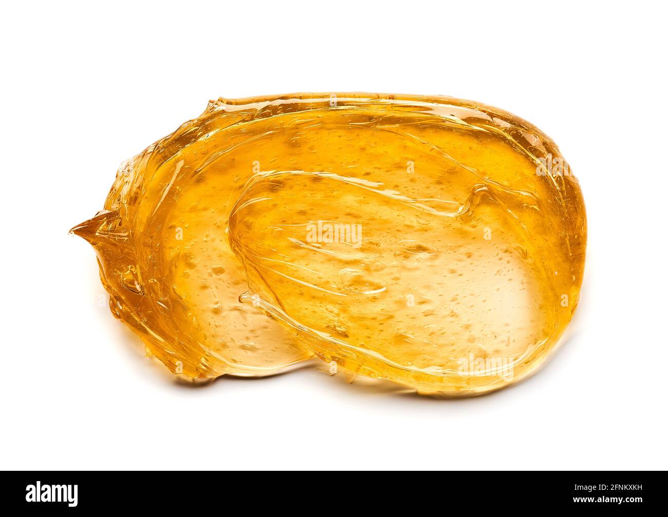 Transparent yellow smear of face cream or golden honey isolated on ...