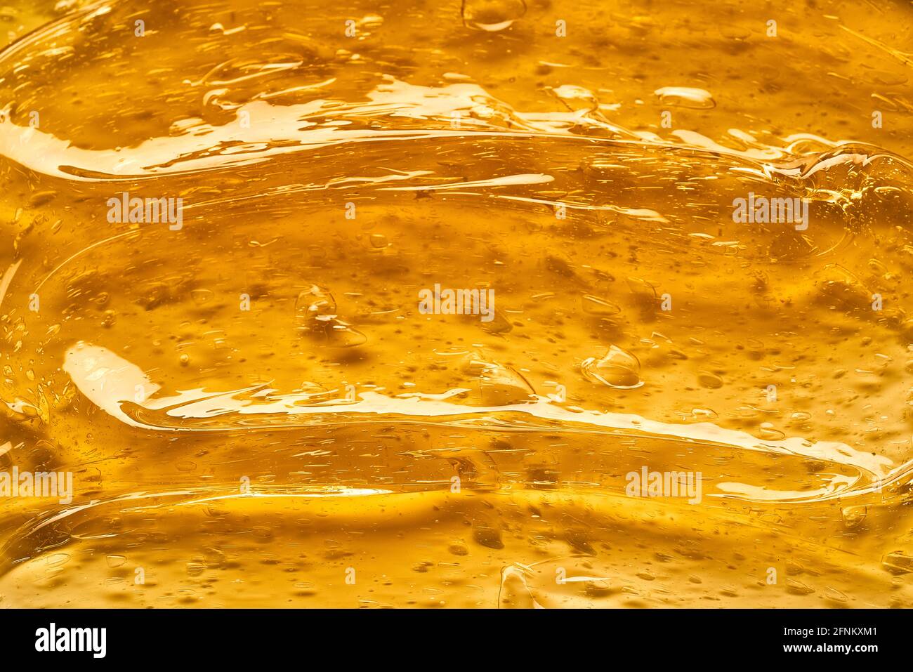Transparent yellow smear of face cream or golden honey isolated on ...