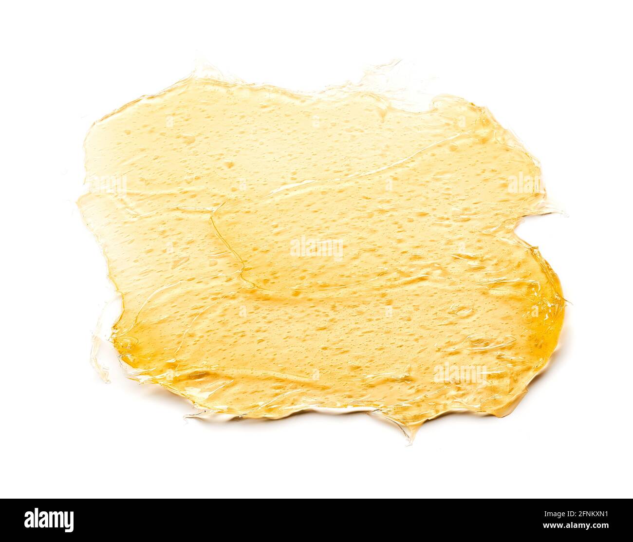 Transparent yellow smear of face cream or golden honey isolated on ...