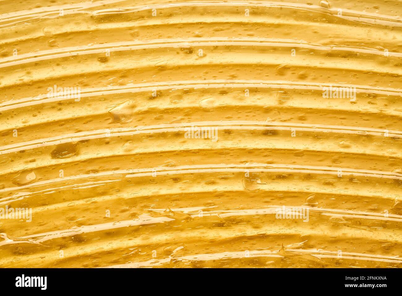 Transparent yellow smear of face cream or golden honey isolated on ...