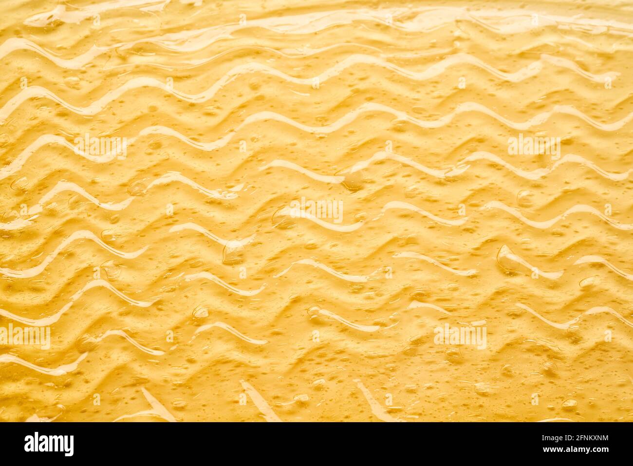 Transparent yellow smear of face cream or golden honey isolated on ...