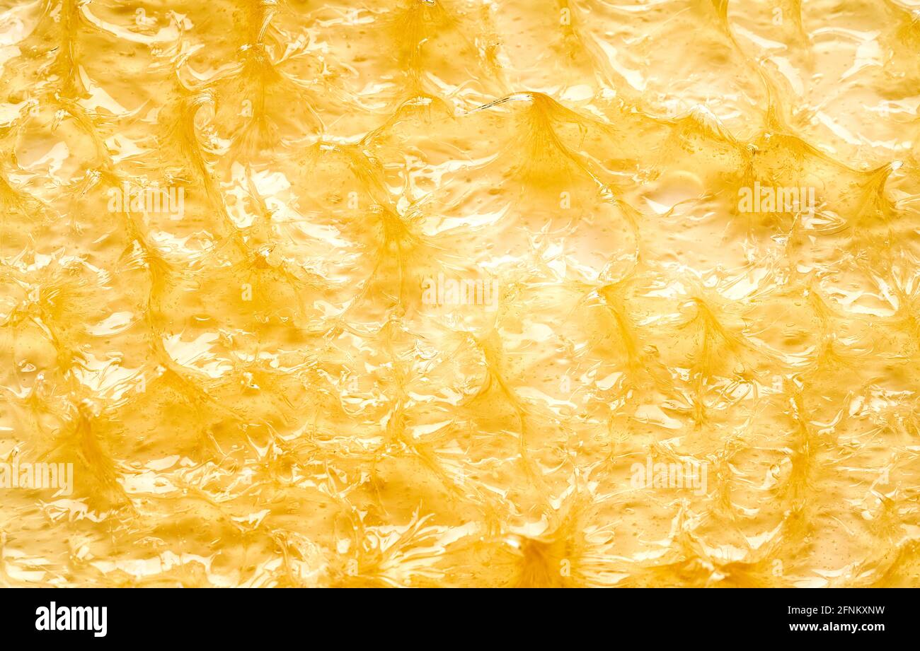 Transparent yellow smear of face cream or golden honey isolated on ...