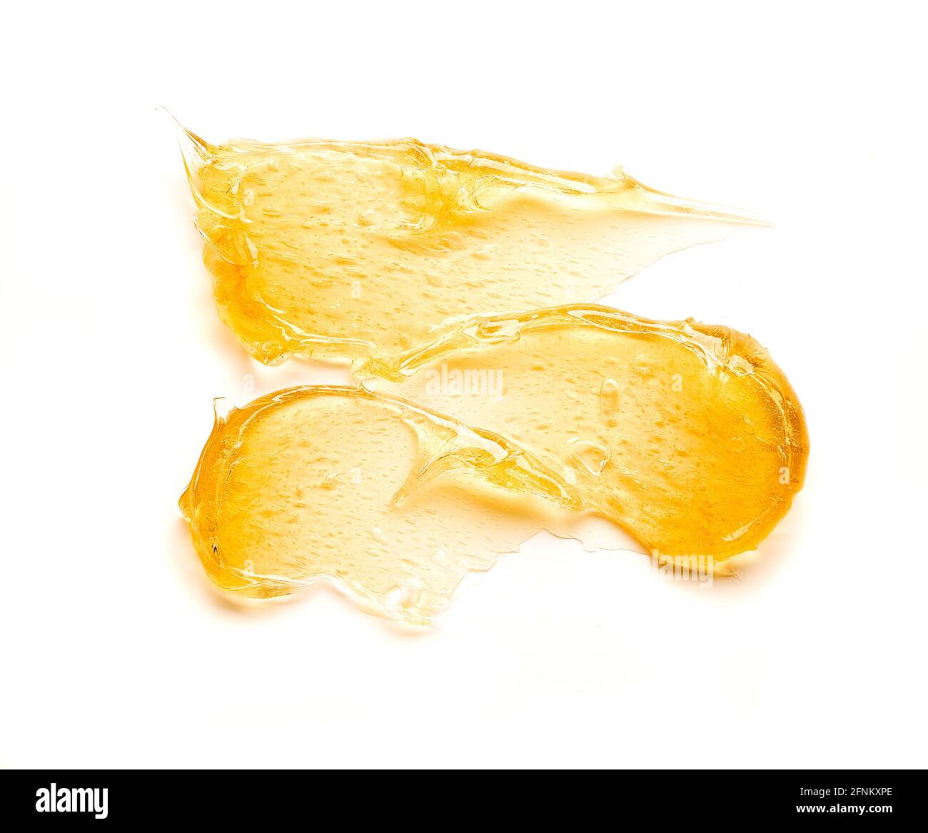 Transparent yellow smear of face cream or golden honey isolated on ...